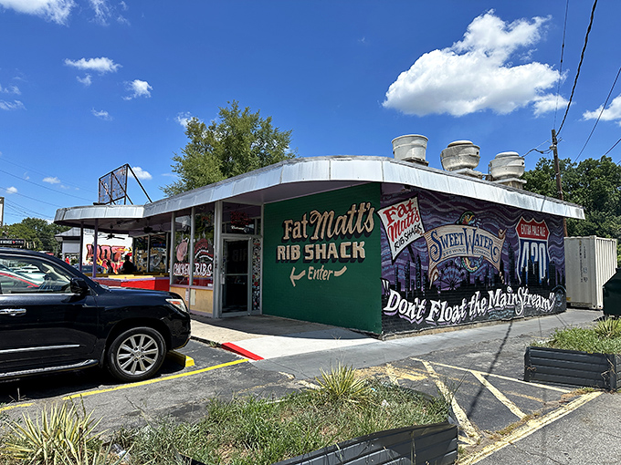 The unassuming green exterior of Fat Matt's might not scream "culinary landmark," but that SweetWater mural whispers, "locals know better."