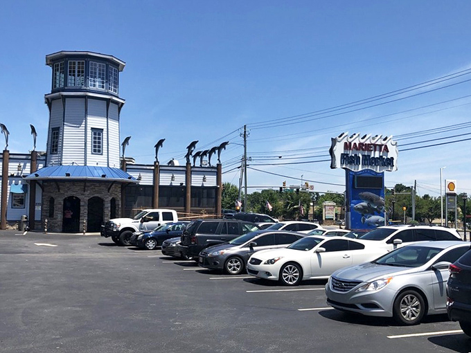 The lighthouse-topped exterior of Marietta Fish Market stands like a coastal beacon in suburban Atlanta, promising seafood treasures within.