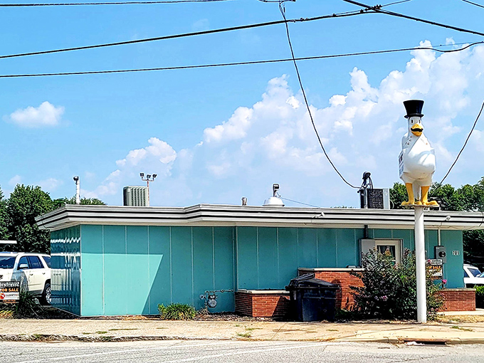 That iconic chicken sign stands proudly like a feathered beacon, promising crispy treasures within this turquoise temple.