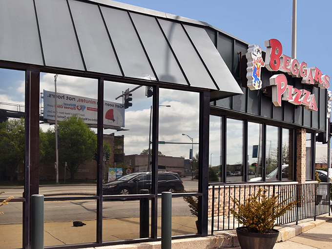 The green-roofed brick facade of Beggars Pizza stands like a beacon of comfort food in Blue Island, promising delicious possibilities within those welcoming walls.