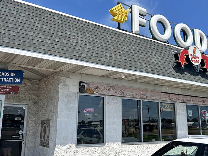 The iconic Cozy Dog sign beckons hungry travelers like a Route 66 lighthouse, promising comfort food salvation just off the highway.