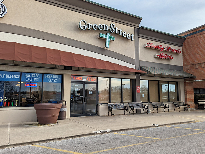 The unassuming exterior of Green Street Pub & Eatery, where culinary magic happens behind that glowing sign. Even race cars make pit stops here!