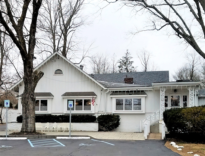 The unassuming white farmhouse exterior of Hollyhock Hill stands like a time capsule of Midwestern dining, promising comfort food treasures within.