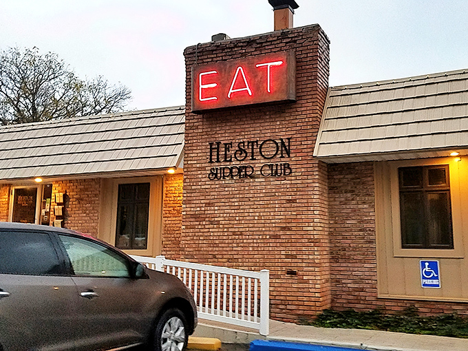 The unassuming exterior of Heston Supper Club with its iconic "EAT" sign is like a culinary bat signal for steak lovers across Indiana.