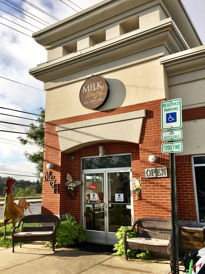 The welcoming brick facade of Milk & Honey beckons like a southern grandmother with fresh biscuits cooling on the windowsill. Those benches outside? They're not just decoration.