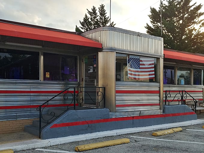 The classic silver-and-red exterior of Tastee Diner stands like a time machine on Route 1, complete with American flag proudly declaring its diner citizenship.