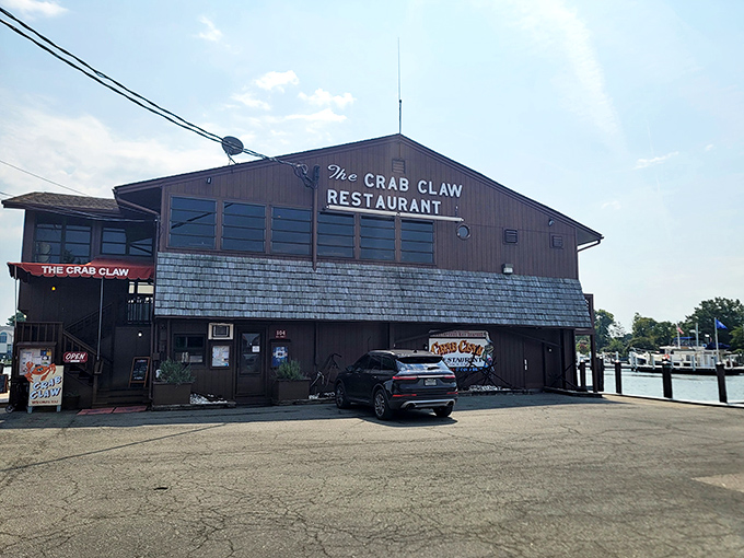 The Crab Claw stands proudly over the water like a rustic sentinel of seafood, its weathered exterior promising authentic Maryland flavors within.