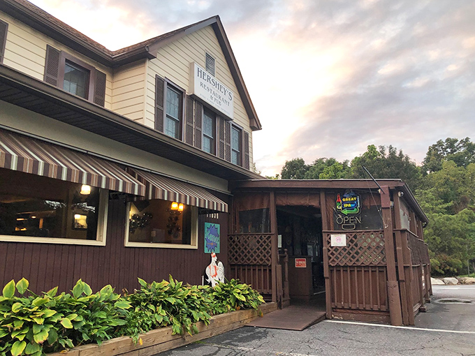 The classic yellow and brown exterior of Hershey's Restaurant stands like a beacon for fried chicken pilgrims, complete with lush hostas and welcoming striped awnings.
