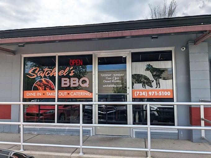 The unassuming exterior of Satchel's BBQ proves once again that the best smoke joints often hide in plain sight. Barbecue paradise awaits behind that red awning.