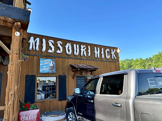 The rustic wooden facade of Missouri Hick Bar-B-Q stands proudly along Route 66, like a barbecue beacon calling hungry travelers home.