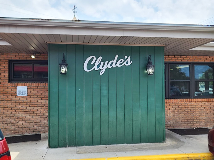 The green-paneled facade with simple white script might not scream "culinary destination," but locals know better. This unassuming entrance hides delicious treasures within.