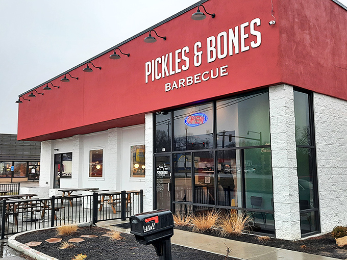 The bright red exterior of Pickles & Bones stands like a barbecue beacon in Milford, promising smoky delights within. That pig knows what's up.