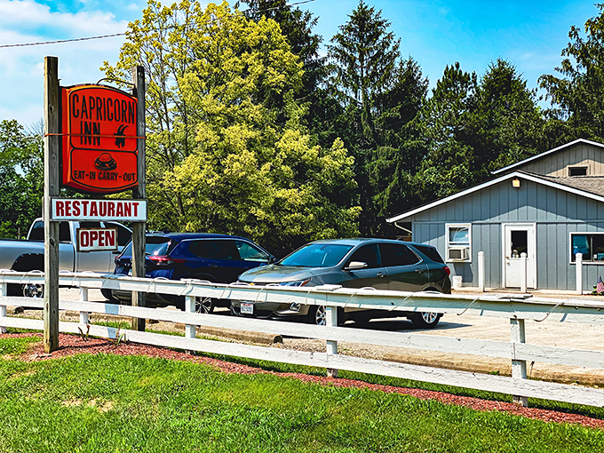 The unassuming blue exterior of Capricorn Inn might not scream "culinary destination," but those American flags hint at the patriotic duty of serving incredible burgers inside.