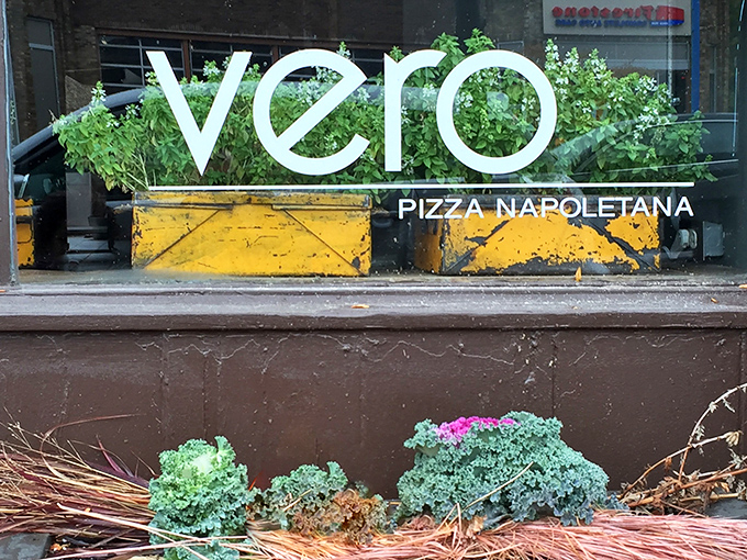 The golden lettering of Vero Bistro beckons like a whisper of Naples against the dark fa&ccedil;ade, promising authentic Italian delights within.