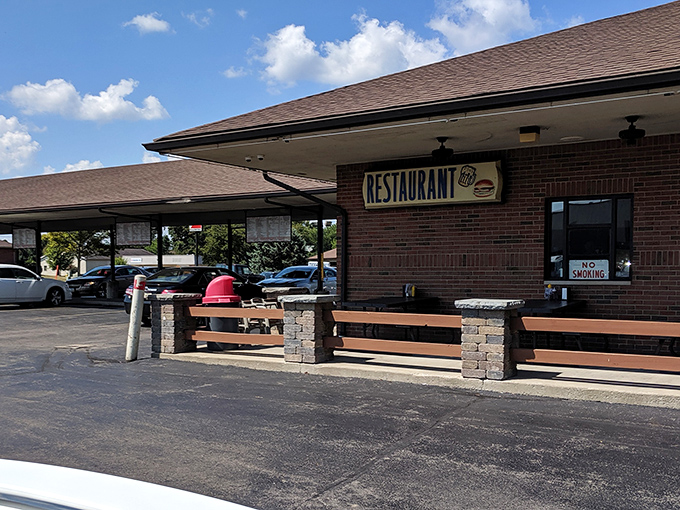 The classic drive-in canopy at B & K Root Beer Stand beckons like a time portal to simpler days when carhops and conversation were the original social media.