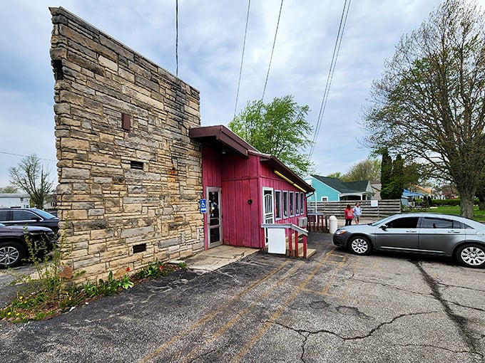 The stone facade and bright red exterior of Porky's stands like a culinary time capsule, preserving flavors that chain restaurants can only dream of replicating.