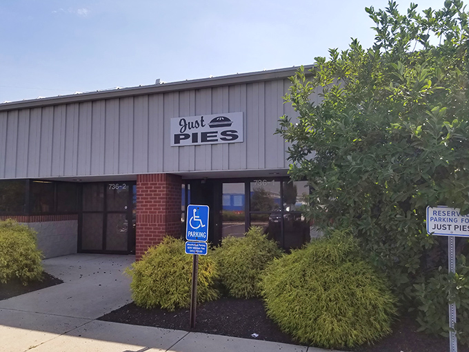 The unassuming exterior of Just Pies belies the magic happening inside. Like finding a treasure chest disguised as a storage shed.