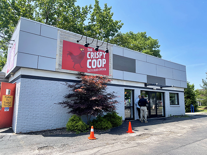 The unassuming blue brick exterior of The Crispy Coop hides culinary treasures within, like a superhero's secret identity for fried chicken excellence.