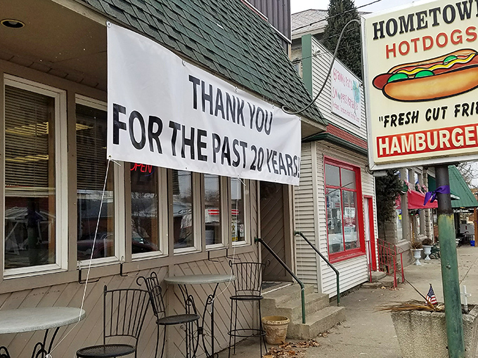 The green-shingled roof and cozy exterior of Hometown Hot Dogs beckons like an old friend waiting with open arms and sizzling grills.