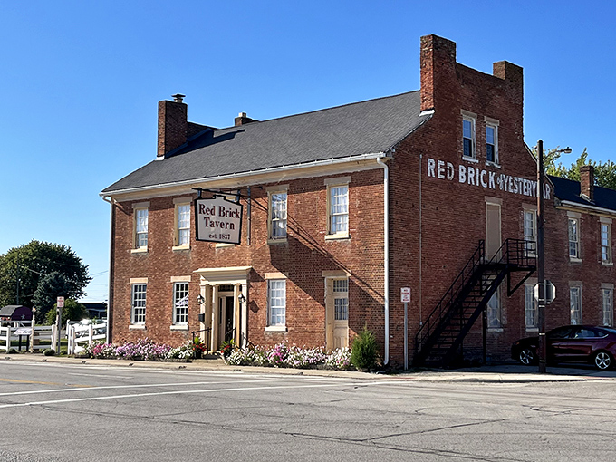 The historic Red Brick Tavern stands proudly along the National Road, its weathered fa&ccedil;ade a testament to nearly two centuries of American history and hospitality.