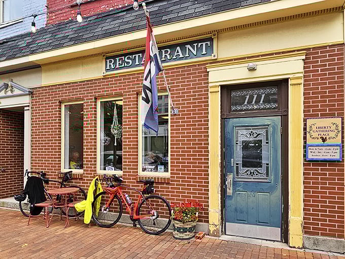 The blue door beckons like an old friend, promising comfort and calories in equal measure. Liberty Gathering Place's brick exterior whispers "come on in" to hungry travelers. 