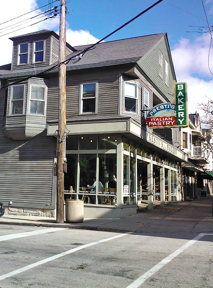 The iconic green and red neon sign of Presti's Bakery stands as a beacon of Italian deliciousness in Cleveland's Little Italy neighborhood, promising sweet treasures within.