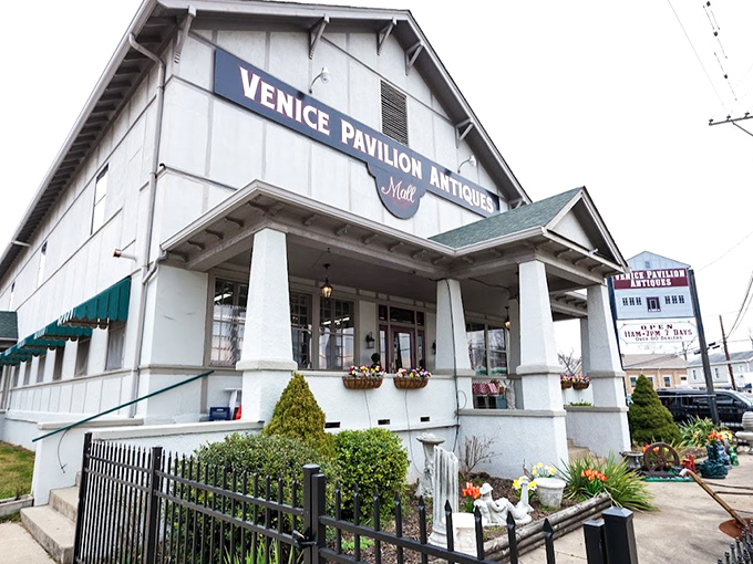 The white clapboard exterior of Venice Pavilion Antiques stands like a time capsule on the corner, promising treasures within that HGTV stars would battle over. 