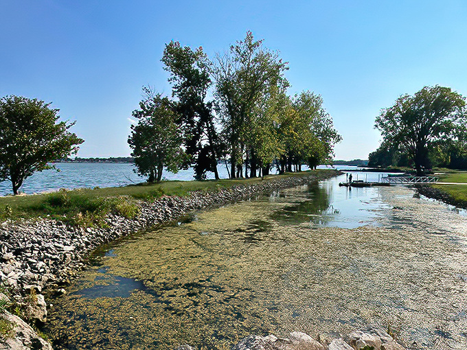 The stone breakwater stretches into Lake Erie like nature's runway, inviting visitors to stroll between two worlds of rippling blue.