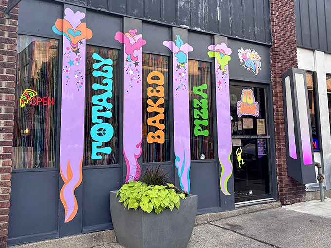 The psychedelic storefront of Totally Baked Pizza looks like the 1970s and 2020s had a delicious love child on Akron's High Street.