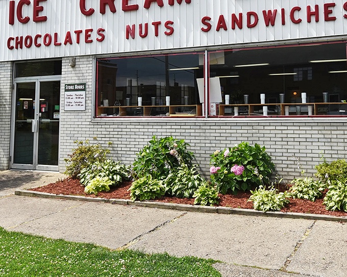 The classic white brick fa&ccedil;ade of Tom's Ice Cream Bowl stands as a time capsule of Americana, promising sweet memories and even sweeter treats inside.