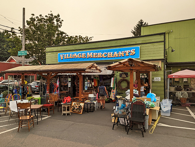 The unmistakable green facade of Village Merchants stands like a beacon of secondhand treasures on SE Division Street, with colorful outdoor displays beckoning passersby to explore.