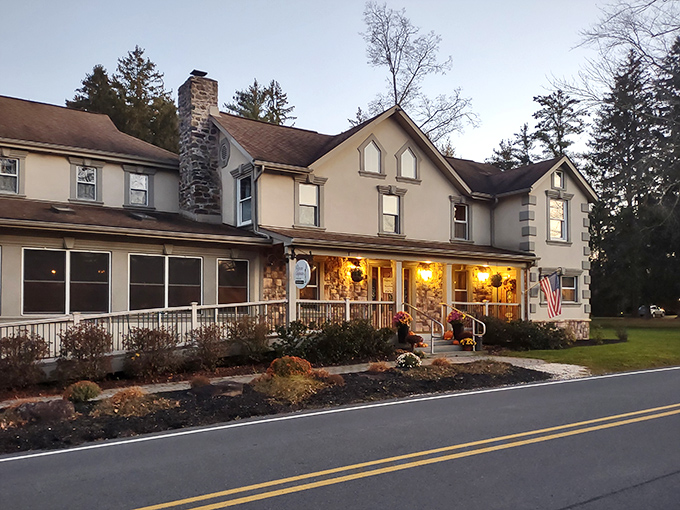The stately exterior of Frogtown Chophouse glows with warm invitation at dusk, like a beacon of culinary promise in the Pocono Mountains.