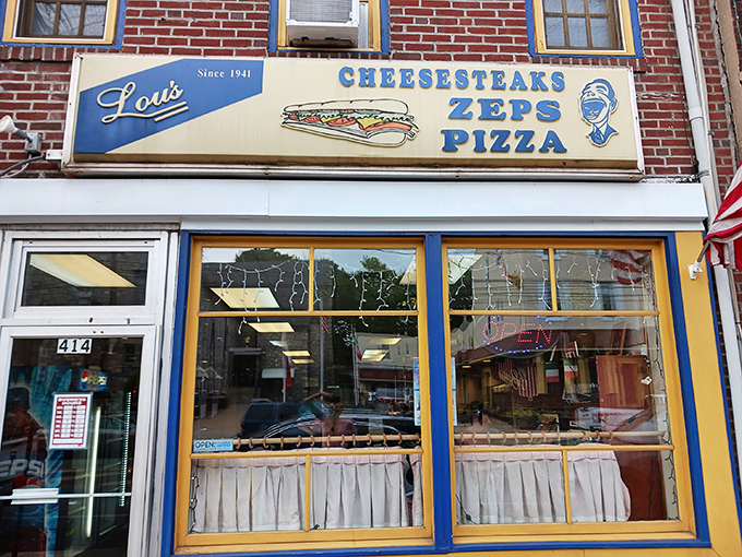The storefront that launched a thousand cravings. Lou's iconic blue and yellow facade has been beckoning hungry Norristown locals since 1941.