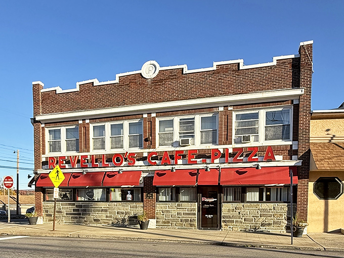 The brick facade and bright red awnings of Revello's stand like a beacon of pizza promise on Old Forge's main drag, beckoning hungry travelers from miles around.