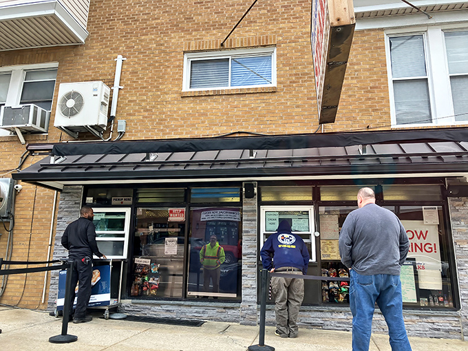 The iconic blue and red sign beckons hungry pilgrims like a sandwich lighthouse. No fancy frills, just the promise of Philadelphia's finest between bread.