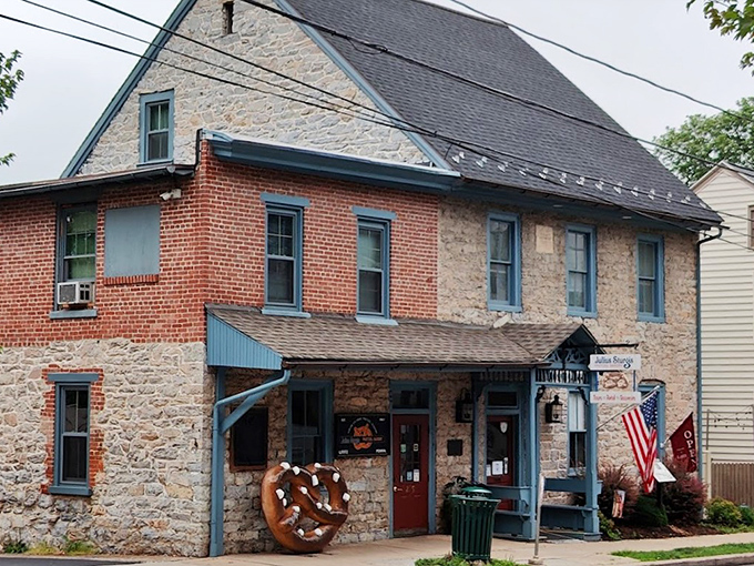 The historic stone and brick facade of Julius Sturgis Pretzel Bakery stands as a testament to American ingenuity, complete with an oversized pretzel sculpture that practically beckons you inside.