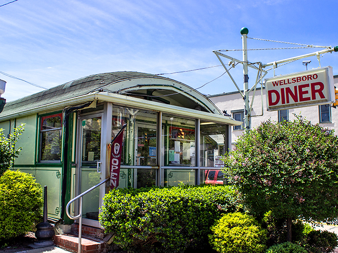 The iconic barrel-roofed Wellsboro Diner stands like a time capsule on Main Street, its vintage sign promising comfort food and nostalgia in equal measure.