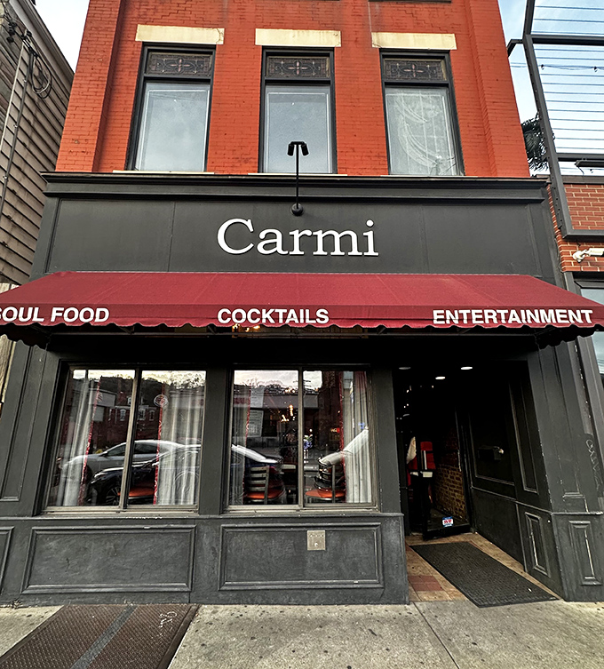 The unassuming brick facade of Carmi Soul Food beckons with a simple promise on its red awning: soul-satisfying Southern cuisine awaits inside.