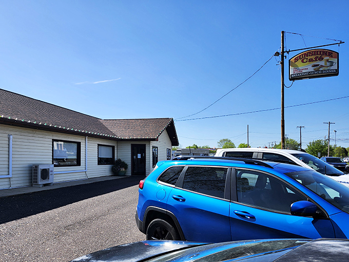 The unassuming exterior of Sunshine Cafe hides culinary treasures within. Like finding a Broadway show in a small-town theater, the packed parking lot tells the real story.