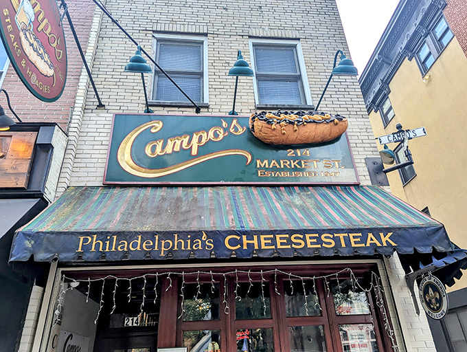 The iconic blue awning of Campo's beckons hungry pilgrims like a culinary lighthouse on Market Street, promising cheesesteak salvation to all who enter.