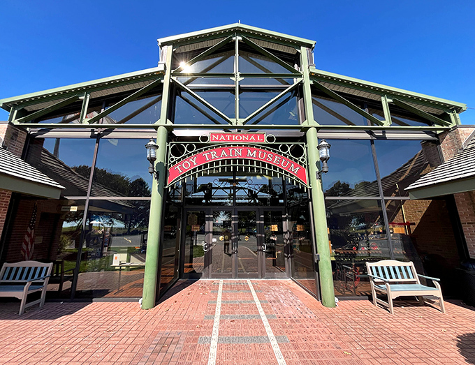 The grand entrance to the National Toy Train Museum stands like a Victorian train station, promising adventures in miniature just beyond those glass doors.