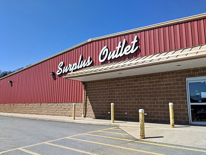 The crimson facade of Surplus Outlet stands like a temple to thriftiness, where shopping carts enter empty but leave triumphantly full.