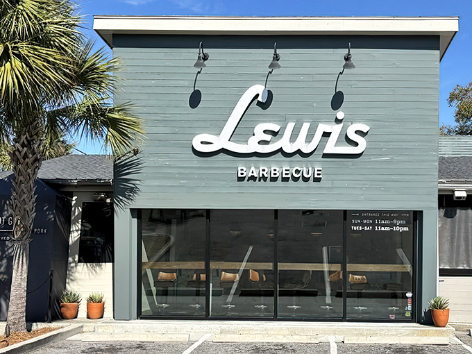 The blue exterior of Lewis Barbecue stands like a smoke-scented beacon in Charleston, with palm trees providing that perfect Southern frame for meat pilgrims.