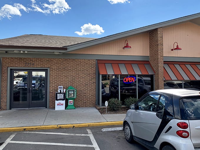 The unassuming brick exterior with its cheerful orange awnings promises what every great diner should: comfort food without pretension.