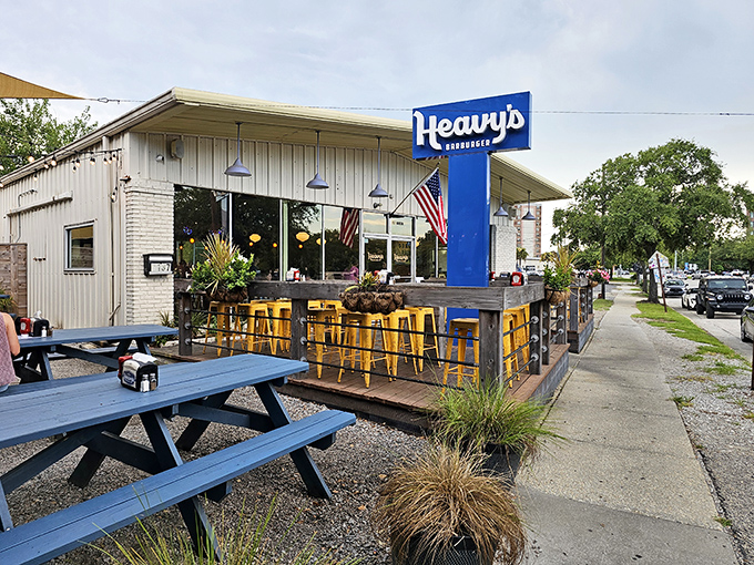 The blue sign beckons like a lighthouse for hungry souls. Heavy's modest exterior hides Charleston's burger paradise behind its unassuming facade.