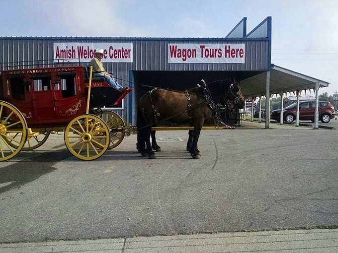 The classic red wagon awaits outside the Amish Welcome Center, where your journey into a simpler time begins with the clip-clop of hooves.