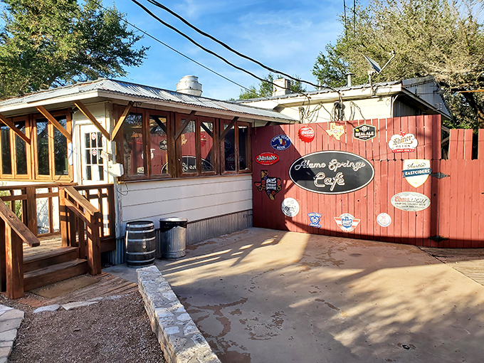 The unassuming red exterior of Alamo Springs Café stands like a burger beacon in the Hill Country wilderness. Texas food pilgrims know: appearances can be deliciously deceiving.