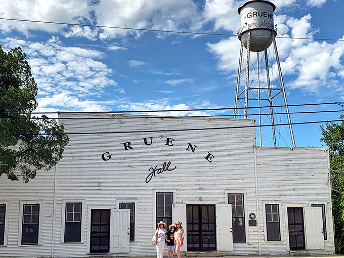 The weathered white clapboard exterior of Gruene Hall glows at dusk, like a beacon calling home wandering Texas souls seeking authentic music and cold beer.