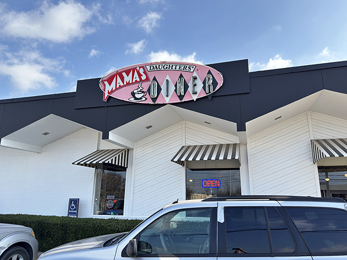 The iconic white building with its distinctive red signage stands like a beacon of breakfast hope against the Texas sky.