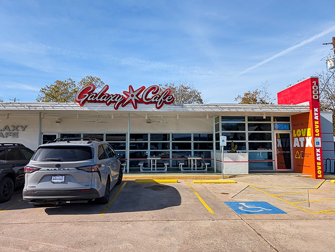The iconic red Galaxy Cafe sign welcomes hungry Austinites like a beacon of breakfast hope. Simple exterior, extraordinary flavors await inside.